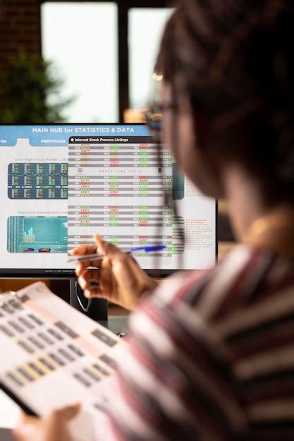 Closeup Of Freelancer Comparing Business Data Free Photo