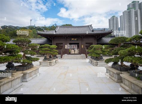 Chi Lin Nunnery Entrance With A Brown Wooden Structure And A Tiled Roof Flanked By Rows Of