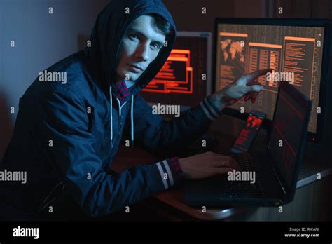 Male In The Hood Looking In The Camera Hacker Attacks And Online Fraud