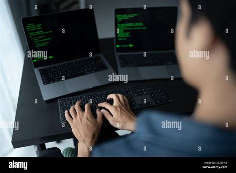 asian man software engineer working on computer at office desk for