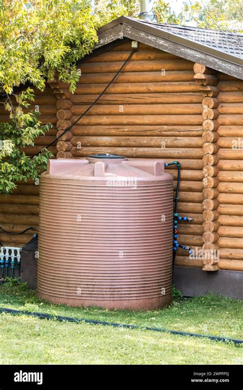 Neat Log House With Overflow Barrel For Outdoor Pool Filling In Green Garden Comfortable Rural
