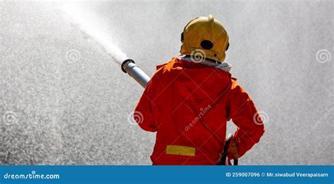 Asian Firefighter On Duty Firefighting Spraying Chemical Foam Asian