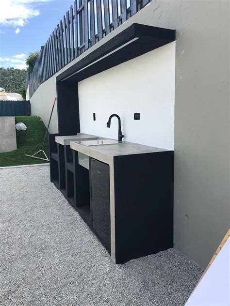 Outdoor Kitchen With Black And White Cabinets