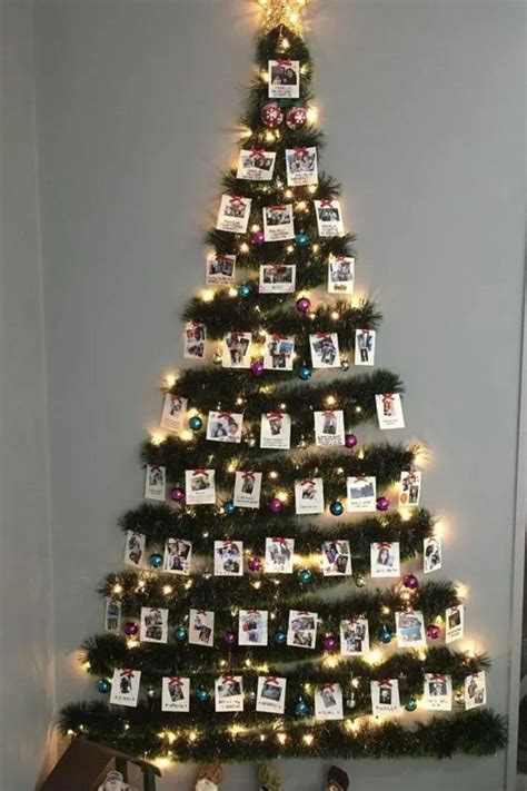 A Small Christmas Tree With Pictures On It
