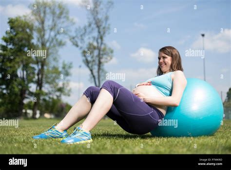 Beautiful Young Pregnant Woman Exercises With Fitball In The Gym Stock