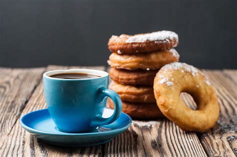 뜨거운 검은 커피의 전체 컵 근처 가루 설탕의 크림 뿌려하지 않고 수제 구운 도넛의 많은 오래된 소박한 나무 테이블에 놓여 가루 설탕에 대한 스톡 사진 및 기타 이미지