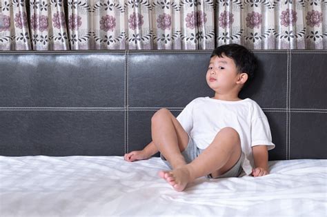 3 년 오래 된 작은 귀여운 아시아 소년 집에서 침대에 아이 연주와 웃는 베개와 담요 복사 공간 흰색 침대에 누워 가족에 대한