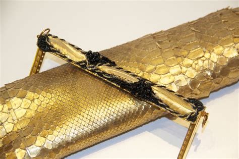 Gold Matte Python Against A Gold And Black Beaded Feather Frame