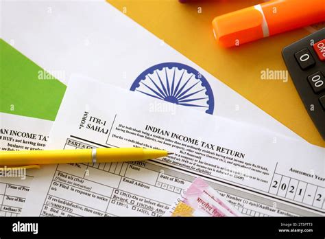 Indian Income Tax Return Blank Form With Pen And Indian Rupees Bills On