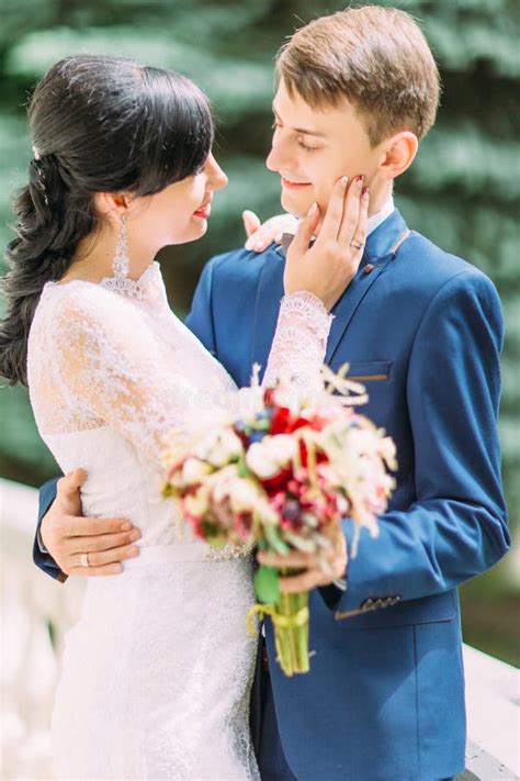 The Newlywed Couple Is Stroking Each Other Cheeks The Close Up Side