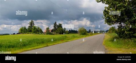 Road Through Farm Land Under A Stormy Sky Abbotsford British Columbia