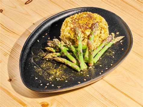 Vegan Curry Risotto With Fresh Green Asparagus Olive Oil And Linseed