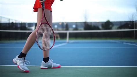 A Woman Doing Her Pre Serve Routine Before She Begins Her Tennis Match