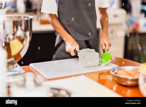 Boy Baking Cake With Hand Cutting Cream Cheese In Kitchen Room Stock