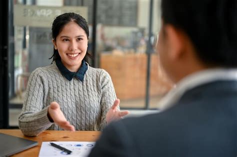 Premium Photo A Smiling Asian Female Office Worker Sharing Her Ideas