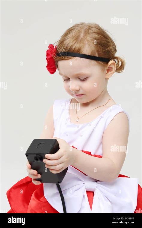 Little Beautiful Girl Holds Black Control Console On White Background