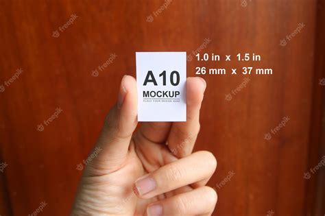 Premium Psd Hand Holding A10 Paper Mockup Simple Clean Modern