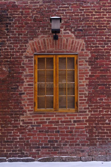 Antique Window With Yellow Wooden Frames On A Red Brick Wall Stock