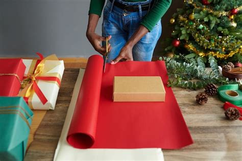 Premium Photo Woman Cutting Wrapping Paper