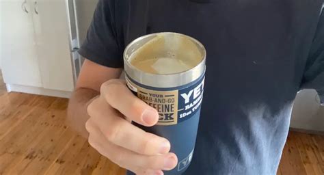 Holding Yeti 10 Oz Tumbler Cup Filled With Coffee The Cooler Box