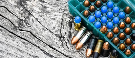 9mm Pistol Bullets And Bullet Shells On Wooden Table Soft And