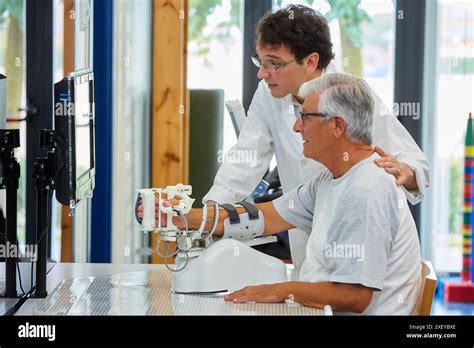 Therapist And Patient With Assistive Robot For Upper Limb Rehabilitation The Robot Armassist