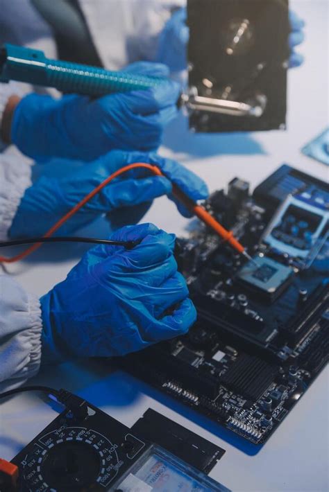 Close Up Of Technician Measuring Voltage Electronic Circuit Board