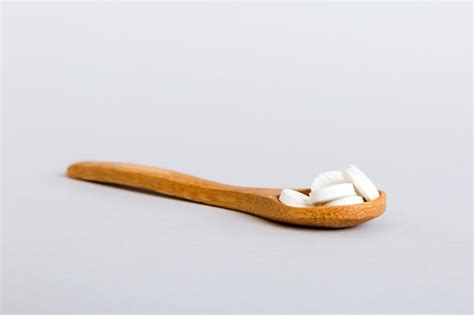 Premium Photo Heap Of White Pills On Colored Background Tablets