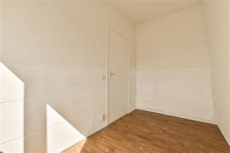 An Empty Room With White Walls And A Wooden Floor Stock Photo Image