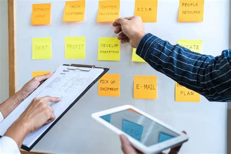 Two Creative Business People Meeting And Planning Use Post It Notes