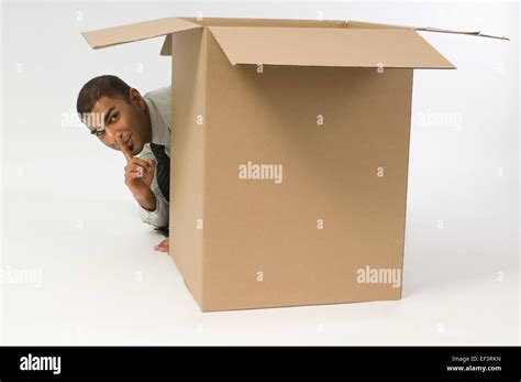 Man Hiding Behind Cardboard Box Hi Res Stock Photography And Images Alamy
