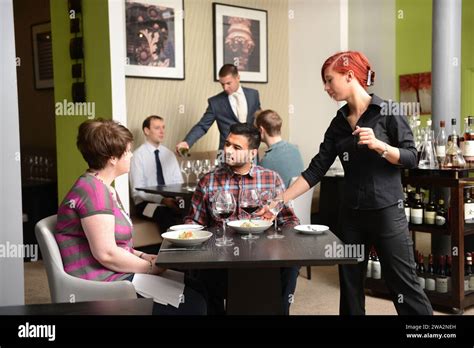 A Waitress Serves Customers In A Restaurant UK Stock Photo Alamy