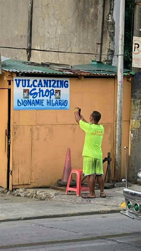 Father Taking A Photo Of His Vulcanizing Shop Business Has Captured The