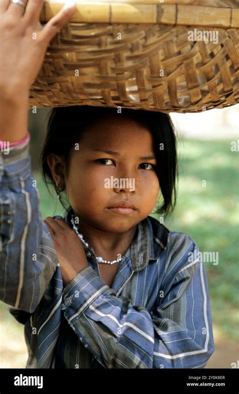 A Khmer Girl Selling Fruit In The Area Around Wat Phnom Temple In Phnom