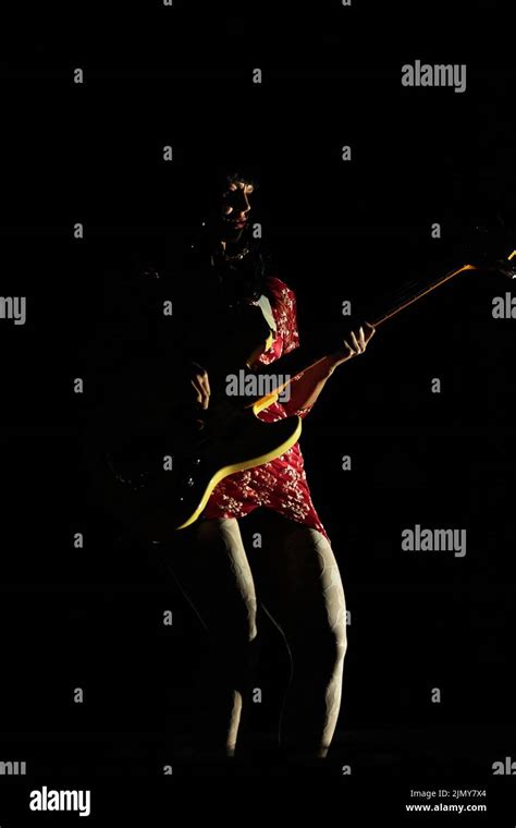 Bassist Laura Lee Of Khruangbin On Stage Wearing A Red Floral Mini