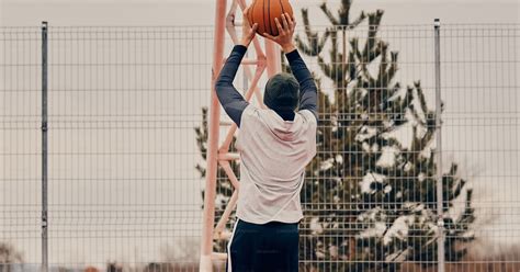 의족을 가진 농구 선수가 야외 스포츠 코트에서 연습하는 동안 총을 쏘는 뒷모습 사진 Unsplash의 세르비아 이미지