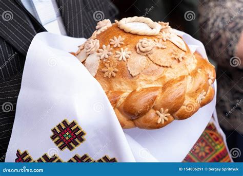 Fresh Bread With Salt To Hold In Hands On A White Embroidered Towel