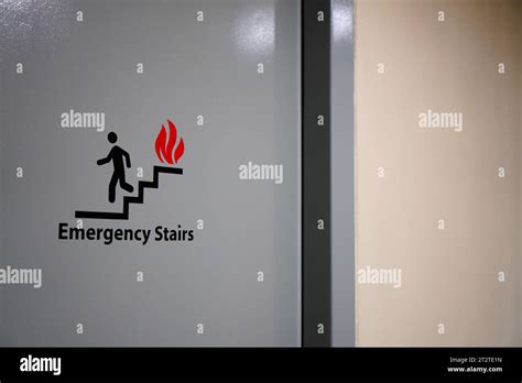 Signage Pointing To Emergency Stairway On Multi Level Structure Stock