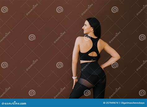 Rear View From Behind A Beautiful Curvy Young Brunette Fitness Trainer