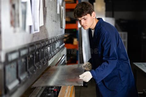 Young Guy Bends Sheet Of Metal Under Pressure Stock Image Image Of