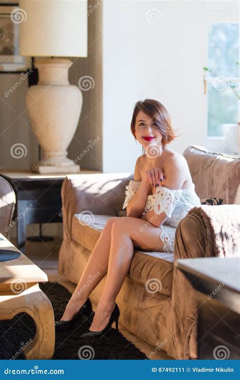 Beautiful Young Woman Sitting On The Sofa And Smiling In The Lux Stock Image Image Of Model