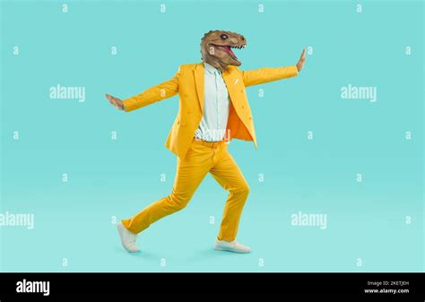 Strange Man In Yellow Suit And Funny Dinosaur Mask Running And Dancing