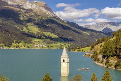 Top View Of A Cruise On Lake Resia Near The Old Submerged Bell Tower Of Curon Venosta South