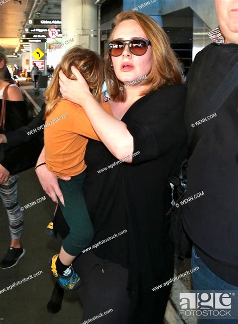 Adele Arrives At Los Angeles International Lax Airport Carrying Her