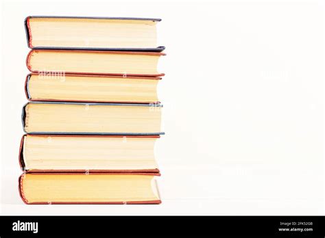 A Stack Of Old Books On A Light Beige Background Copyspace Front View