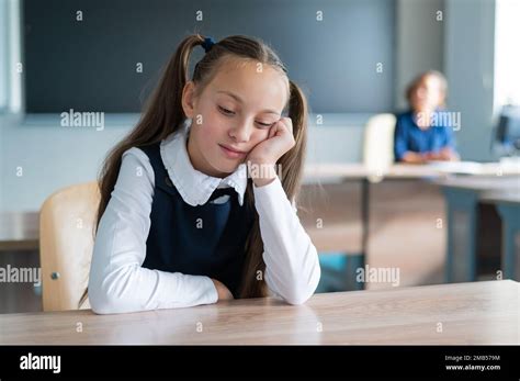 Little Caucasian Girl Is Bored At The Lesson At School The Schoolgirl
