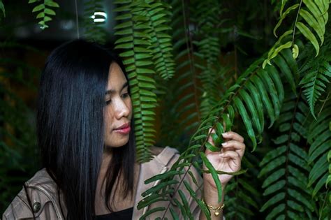Premium Photo Portrait Of Young Woman Looking At Tree