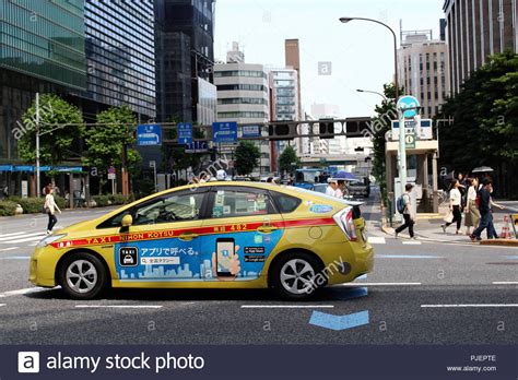 A Toyota Prius Hybrid Taxi Cab Operated By Nihon Katsu Waits At At A
