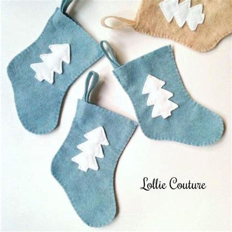 Three Blue Christmas Stockings With White Trees On Them And One Has An