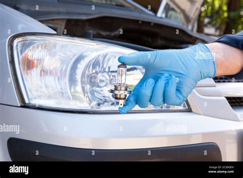 Changing Halogen Bulb In Car Headlight Stock Photo Alamy